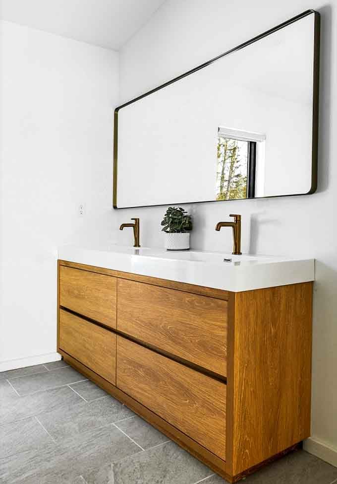 Natural wood vanity with dual sinks means nobody's fighting for mirror space during the morning routine.