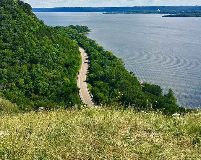 Winding roads hug the bluffside above shimmering water, creating the kind of drive that makes you forget your destination entirely.