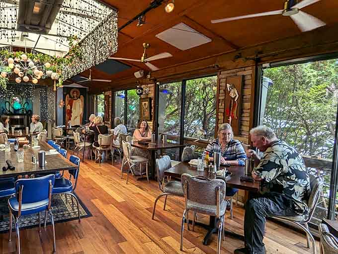 Diners enjoying their meals surrounded by windows and whimsy, because eating should always include a view and conversation.