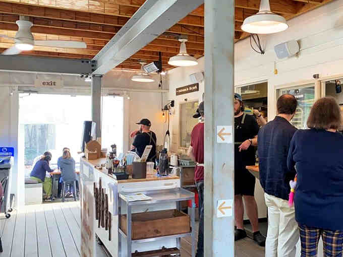 Natural light floods through skylights while the crew works their magic at the spotless counter below.