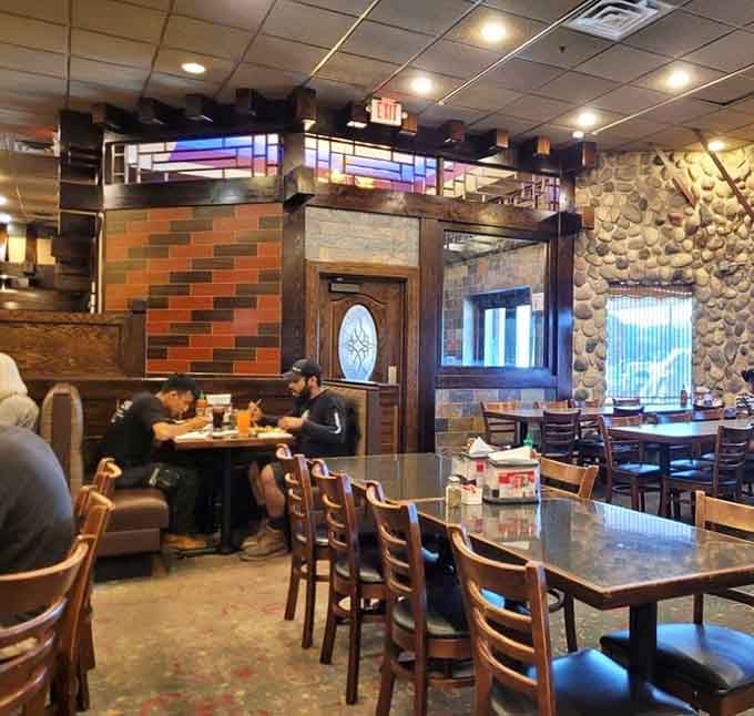 Stone accents and warm lighting create an atmosphere that says yes, fourth helpings are absolutely acceptable here tonight.