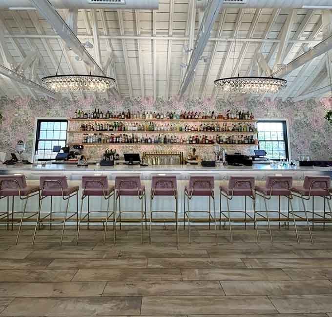 A bar that stretches toward infinity, stocked with enough bottles to make any cocktail lover's heart sing.