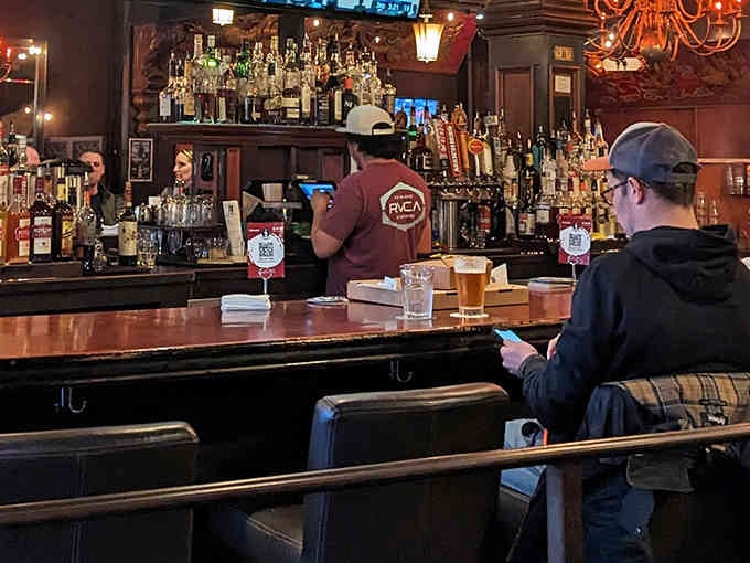 The bar at Talarico's stands ready to provide liquid courage for tackling pizzas that defy all reasonable portion expectations.