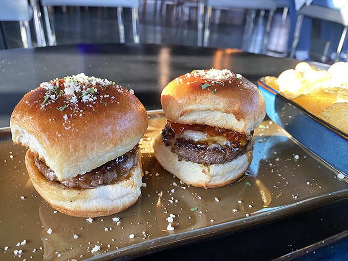 Two perfect sliders dusted with cheese prove that good things really do come in small, delicious packages worth savoring slowly.