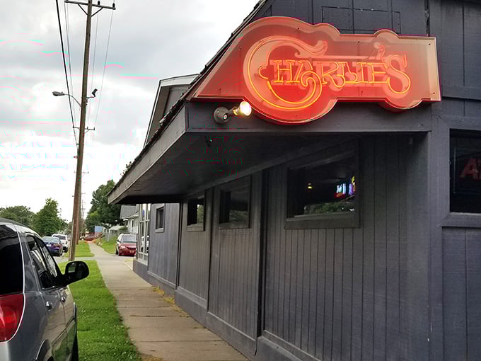 Charlie's neon sign beckons like a friendly neighborhood beacon where comfort food and cold drinks await inside.