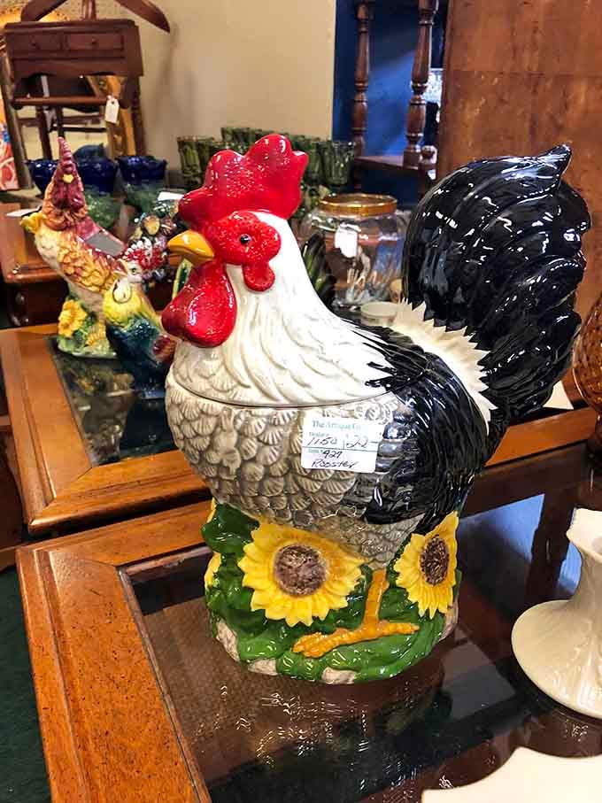 A proud ceramic rooster stands guard over the kitchen collectibles, his glossy plumage catching light like morning sunshine.