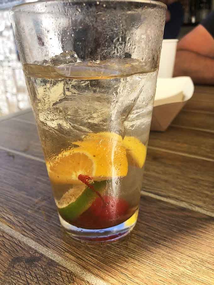 That white wine spritzer with fresh fruit looks refreshing enough to make you forget you're technically still working this week.