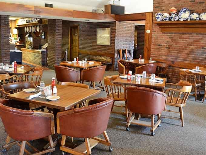 More exposed brick, comfortable seating, and natural light streaming through windows create an inviting atmosphere worth settling into.