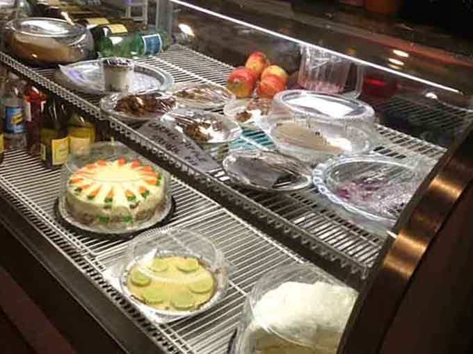 Homemade cakes under glass domes, each one a sweet ending to your literary journey through the stacks.
