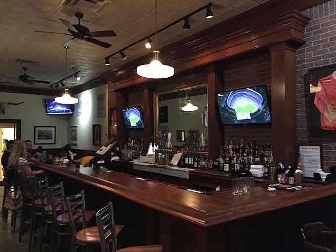 That bar setup with multiple screens and serious bottle selection - your new favorite spot for game day or any day.