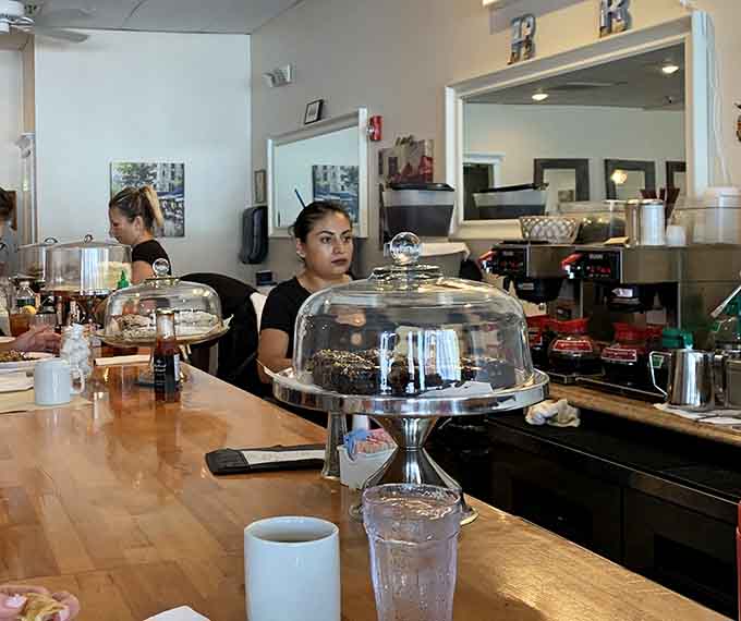 Friendly staff working behind the counter, ready to make your breakfast dreams come true with a smile.