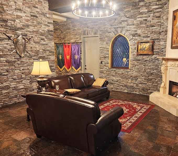 Colorful banners and stone walls create a living room where Game of Thrones fans can finally feel completely at home.