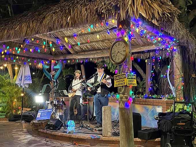 Live music under a thatched tiki hut surrounded by twinkling lights is basically Florida's version of dinner theater done right.