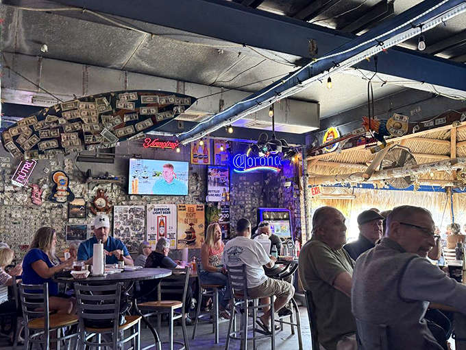 Locals packed inside under thatched roofing, sharing stories and seafood in Florida's most authentic dining room atmosphere.