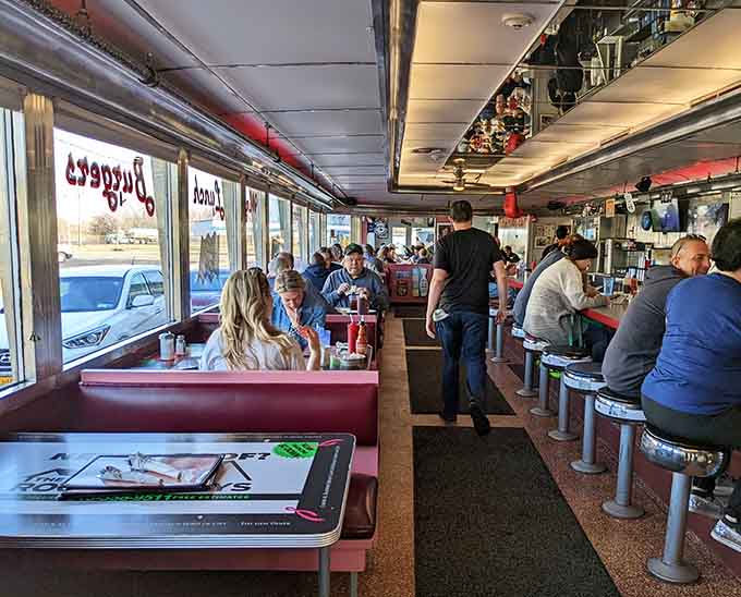 Counter seating and booth diners enjoying their oversized meals in classic diner style at The Gem.
