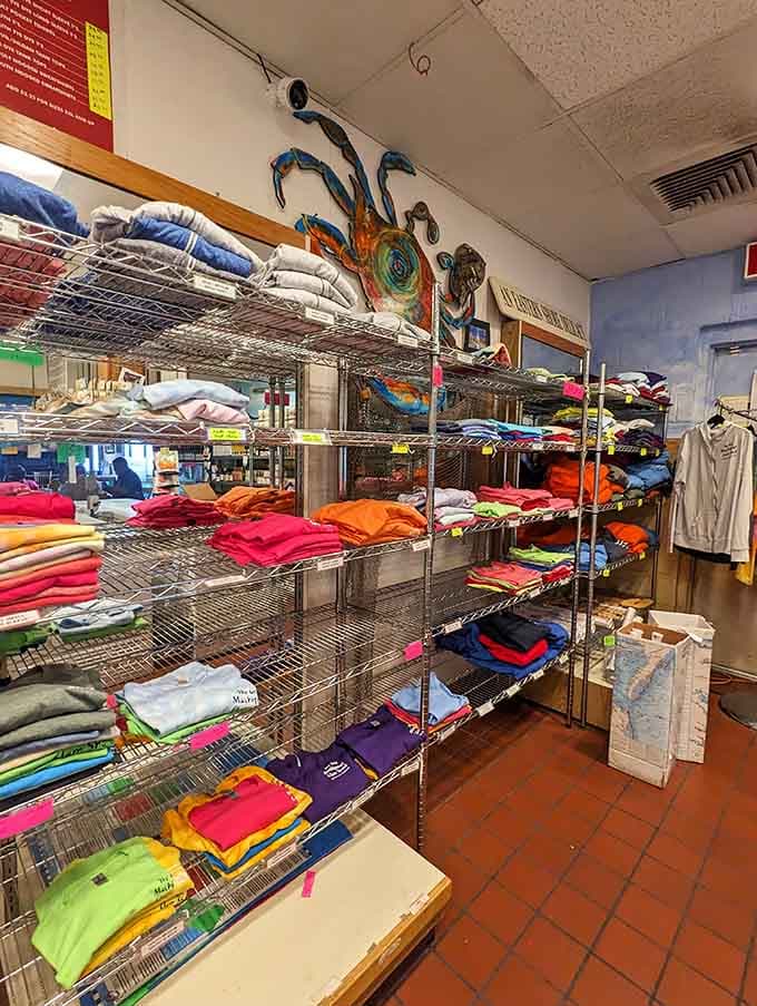 Colorful t-shirts stacked high because great food deserves equally great souvenirs to remember the experience forever.