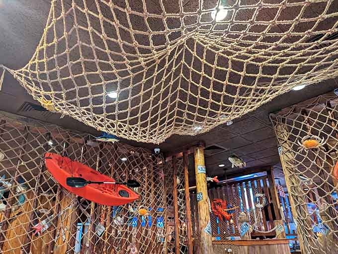 Fishing nets draped across the ceiling create an immersive coastal atmosphere that transports you straight to the bayou.