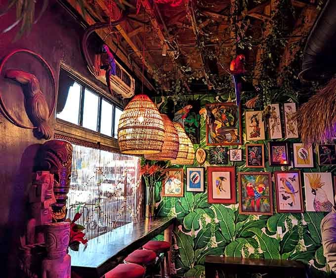 Vintage tropical art and wicker lamps create an atmosphere that's pure escapism with a side of nostalgia.