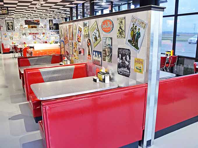 Glossy red booths adorned with retro posters create intimate dining spaces bursting with personality and charm.