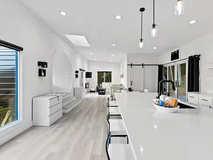 The open floor plan flows seamlessly from kitchen to living space, all anchored by that show-stopping circular bedroom alcove.