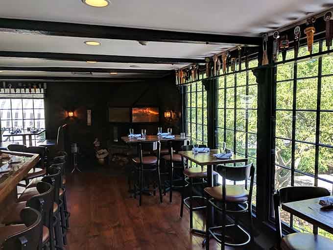 Dark wood and dramatic lighting create an atmosphere where every meal feels like a special event worth celebrating.