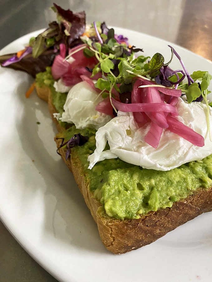 Avocado toast topped with poached eggs, proving this old tavern knows how to speak millennial while honoring tradition.