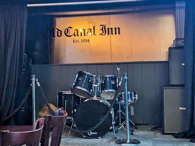 Live music stage ready for local talent, because good taverns know entertainment matters as much as food.