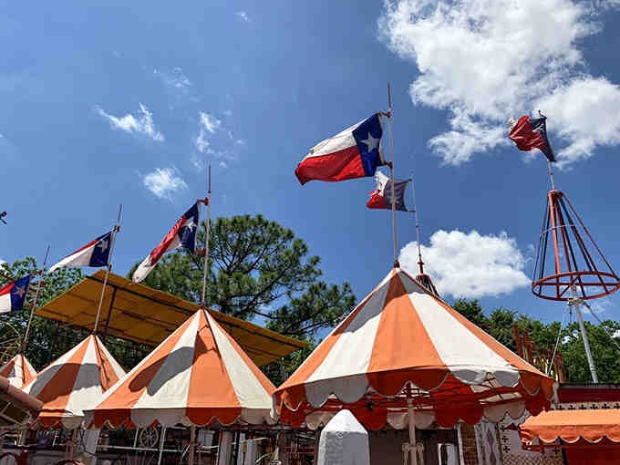 Texas flags flutter above carnival-striped awnings, creating the world's most patriotic fruit tribute you'll ever see.