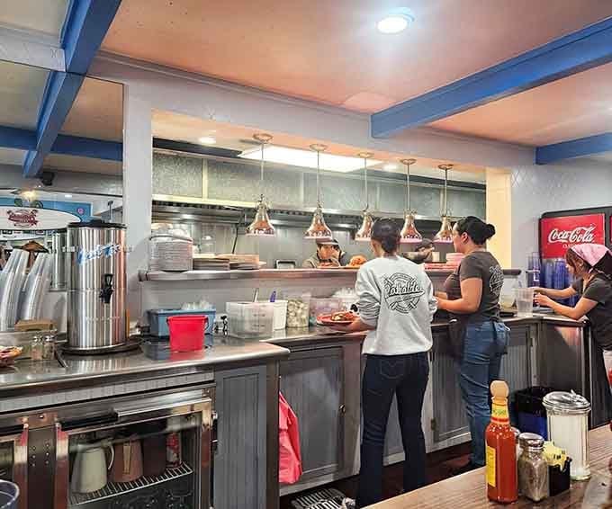 The kitchen crew working with the focused intensity of people who flip 18-inch pancakes for a living.