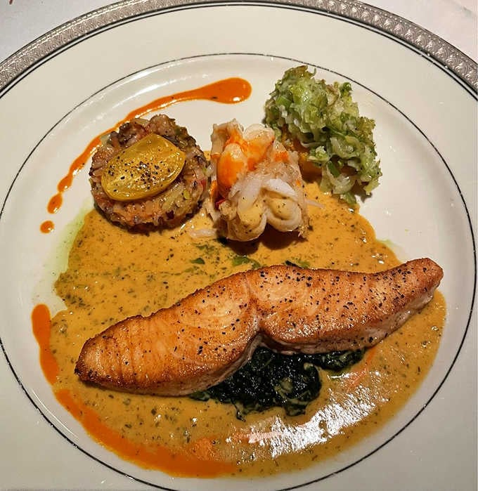 Western Ross salmon resting on wilted greens, surrounded by sauce that's been drizzled with the precision of a surgeon.