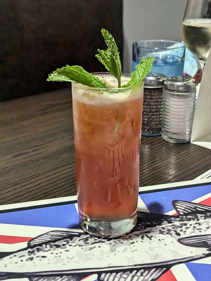 A refreshing cocktail garnished with fresh mint, because even your drink deserves to look like it's on vacation.