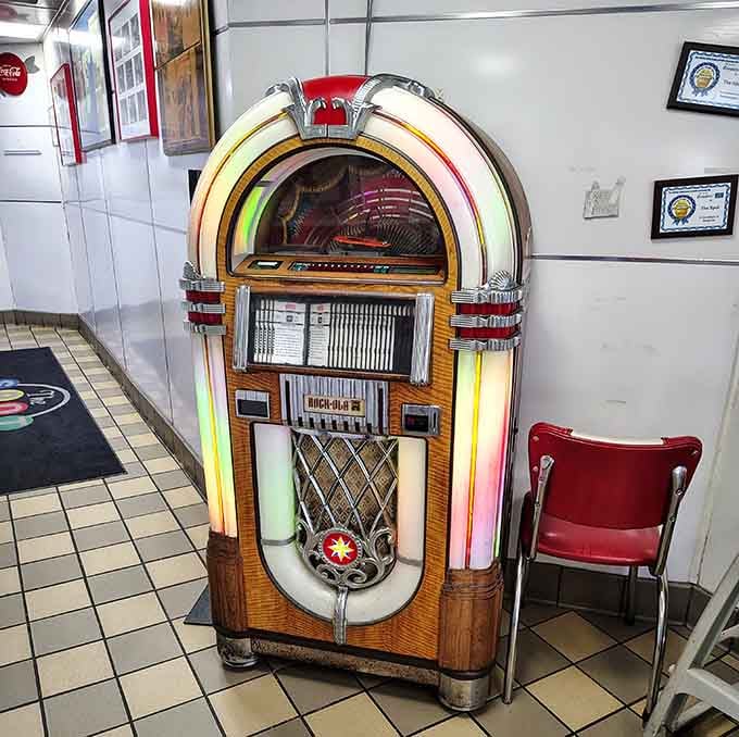 A genuine vintage jukebox adding authentic soundtrack to your meal, because some things shouldn't be modernized ever.