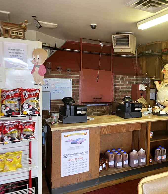 The counter where barbecue dreams are ordered and sauce bottles wait like soldiers at attention below.