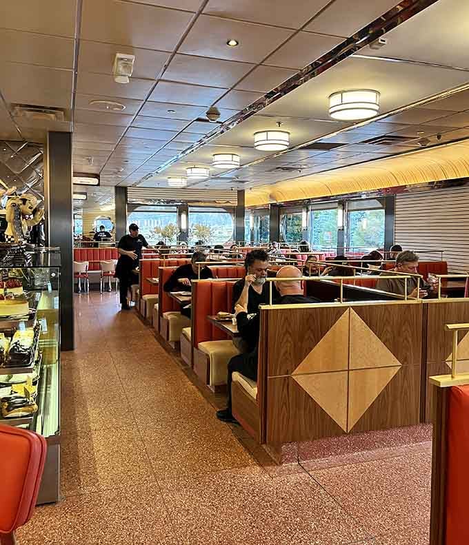 Sunlight streams through expansive windows, illuminating a dining room where strangers become regulars and regulars become family over shared meals.