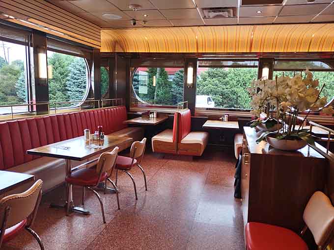 Retro booths with circular windows create a dining experience that's equal parts comfort and cool mid-century style.
