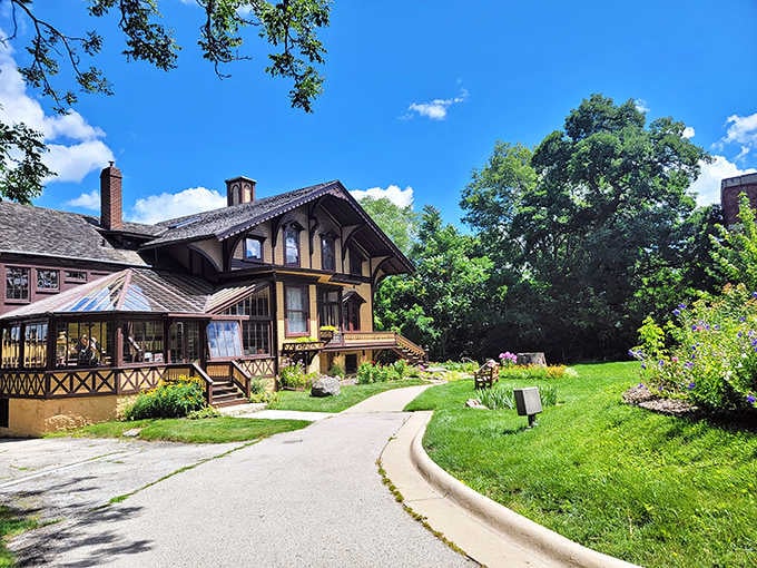The cottage nestled into its hillside like it grew there naturally, architecture and nature in perfect harmony.