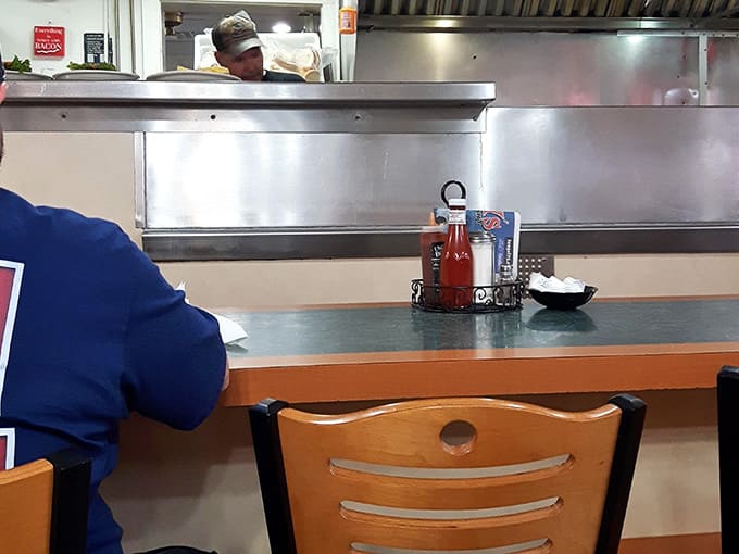 Counter seating offers front-row views of breakfast theater, where eggs and hash browns become edible art daily.