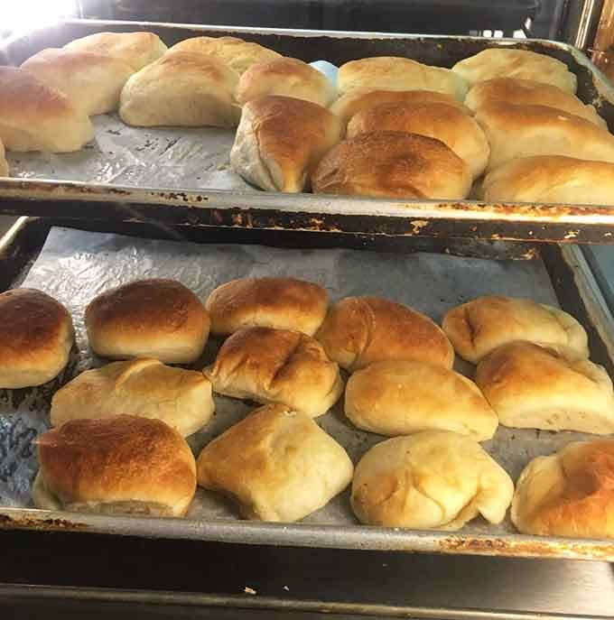 Fresh rolls emerging from the oven represent the warm, yeasty promise of carbohydrates done absolutely right every single time.