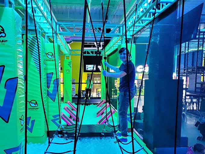The ropes course glows green like some futuristic challenge, testing your balance and your willingness to look silly trying.