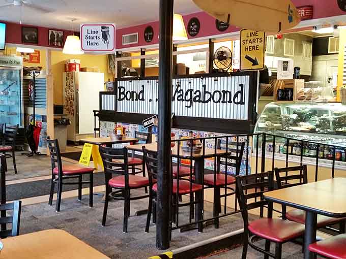 Casual seating, quirky signs, and that "Line Starts Here" reminder, because good sandwiches create happy crowds.