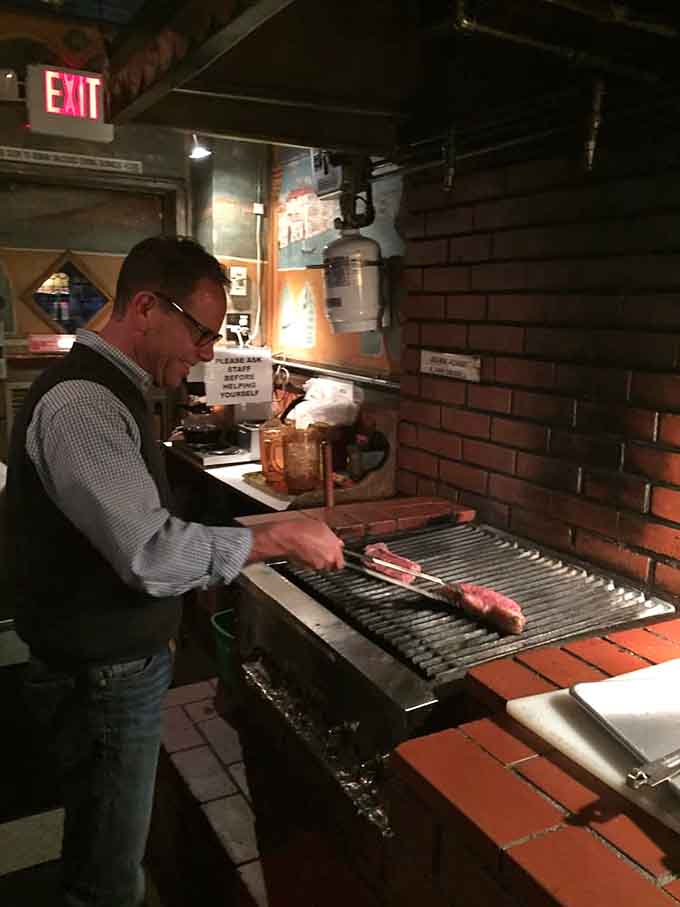 Standing at the communal grill, tongs in hand, living your best backyard barbecue life indoors.