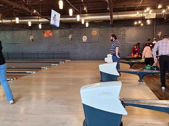 Friends gathered around the lanes, where competition meets camaraderie and everyone's keeping score but nobody really cares.