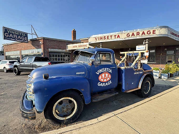 A vintage Vinsetta Garage tow truck parked outside adds authentic automotive history to your dining experience today.