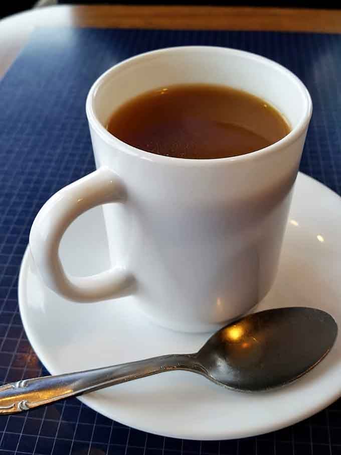 Hot coffee served in a proper ceramic cup, the kind that gets refilled before you even realize you need more.