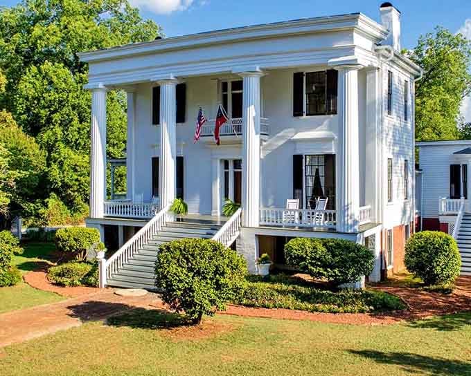 Those stately columns and symmetrical design embody Greek Revival elegance that photographs like a Southern Living cover come to life.