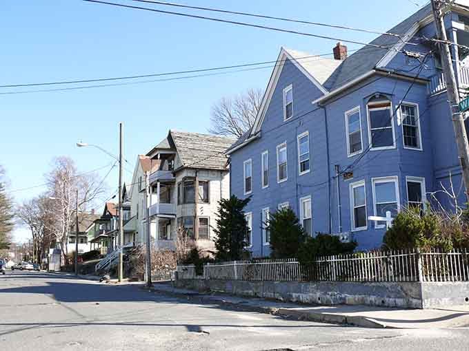 Residential neighborhoods climb the hillsides, each colorful house telling stories of families who built lives here across generations.