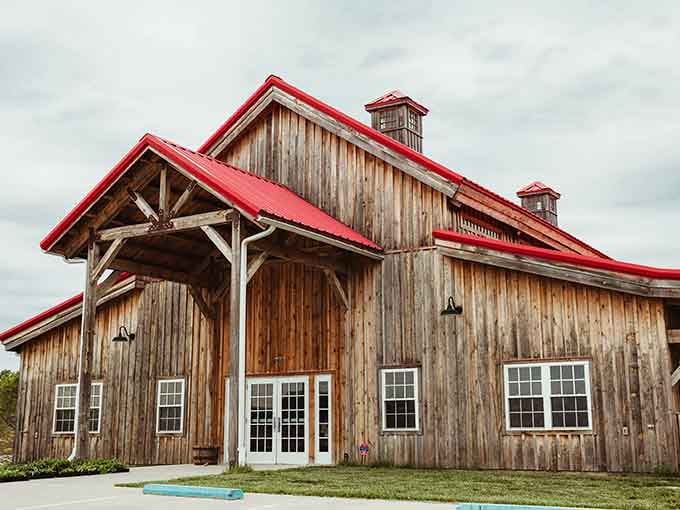 This barn's weathered wood and bright red roof prove that agricultural architecture can be both functional and absolutely Instagram-worthy.