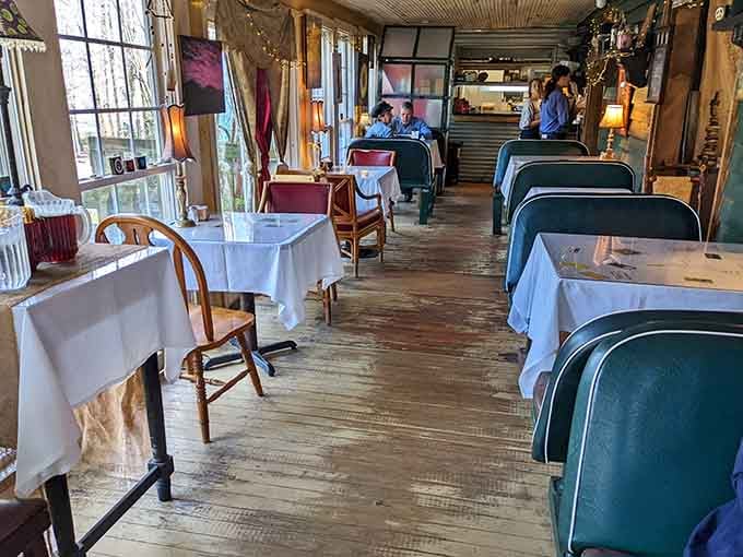 The dining room stretches invitingly with mismatched chairs that somehow feel perfectly coordinated in their charming chaos.