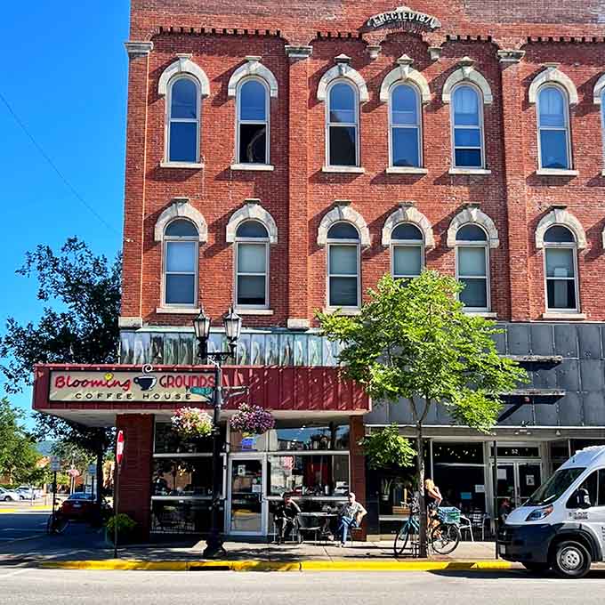 Blooming Grounds beckons from its historic brick building where coffee and conversation flow as freely as the river nearby flows.