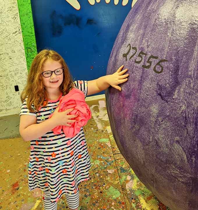 Kids instinctively understand the magic here, touching a surface that represents thousands of days of unwavering creative commitment.